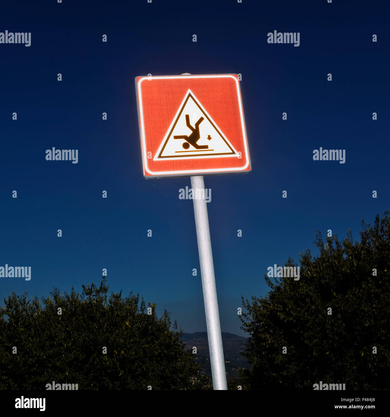 Warning sign against a blue sky, Italy Stock Photo - Alamy