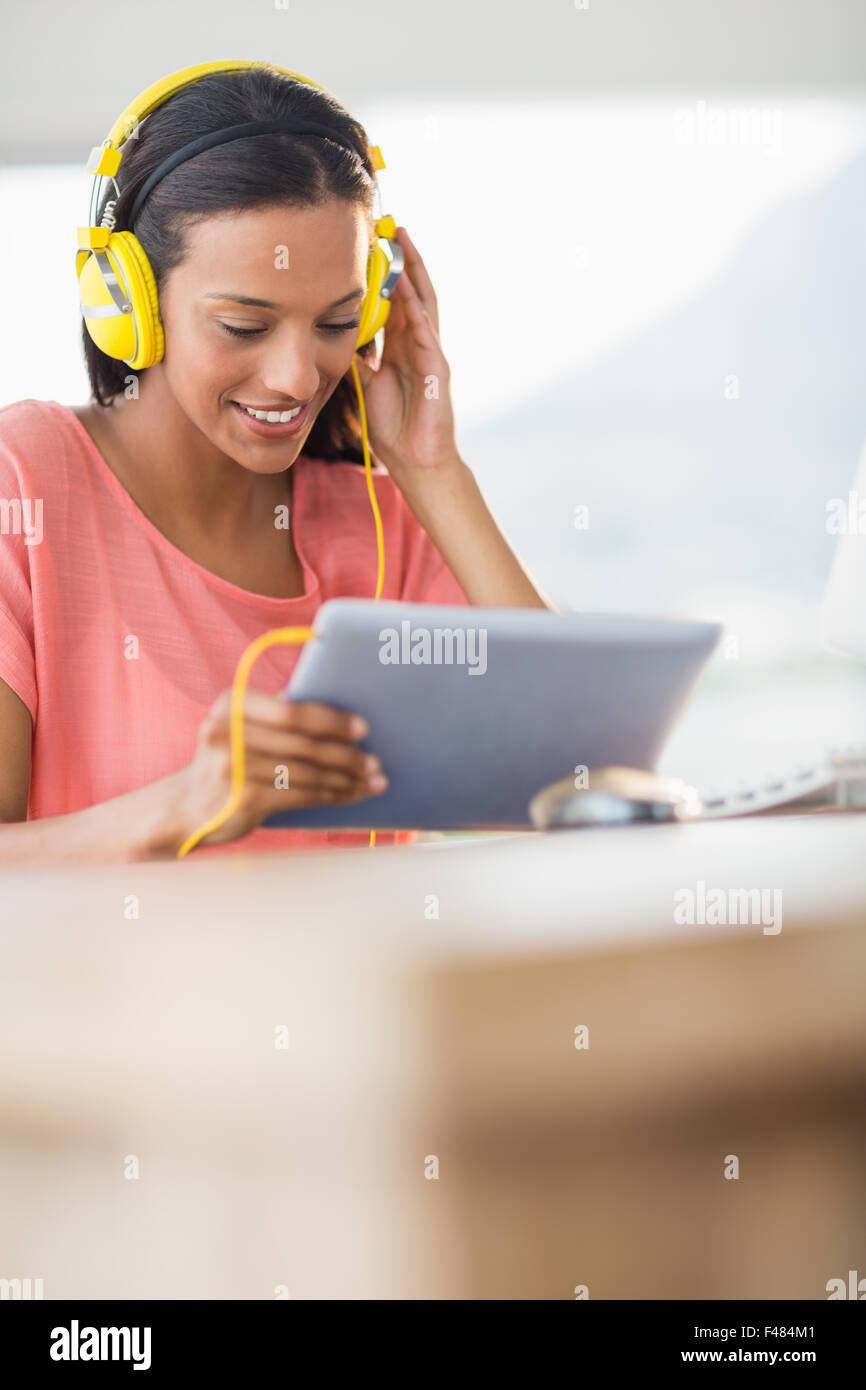 Happy creative businesswoman listening music with her tablet Stock ...
