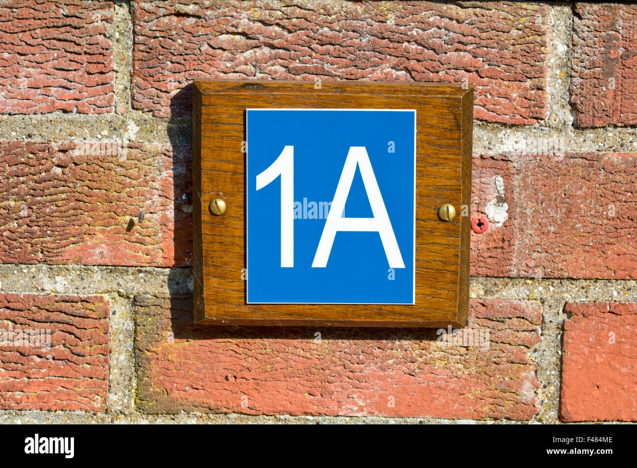 1A House number sign on wall Stock Photo - Alamy