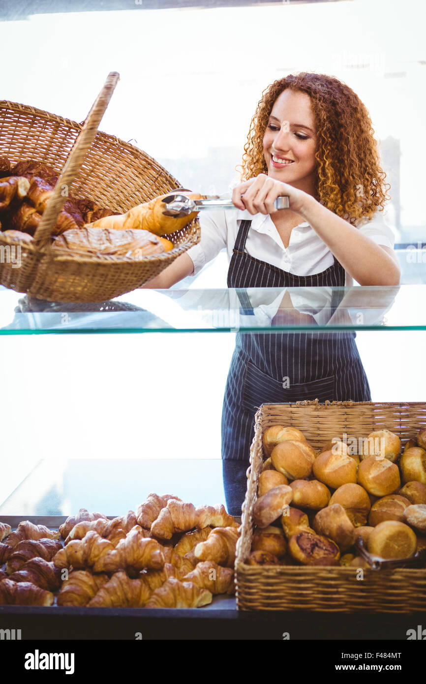Happy pretty barista preparing pastry Stock Photo - Alamy
