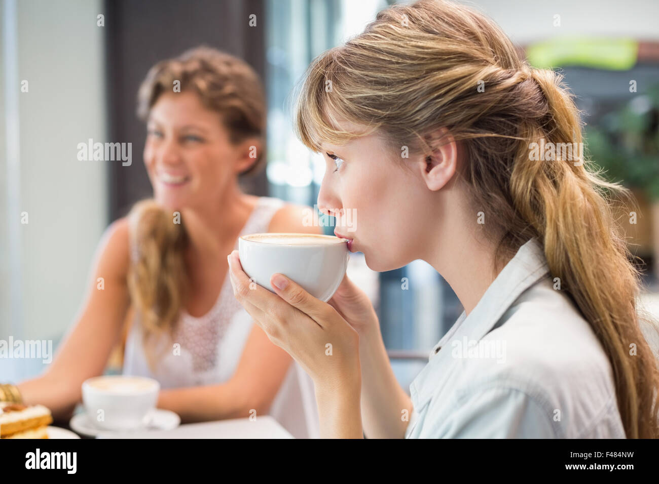 Beautiful woman drinking coffee Stock Photo - Alamy