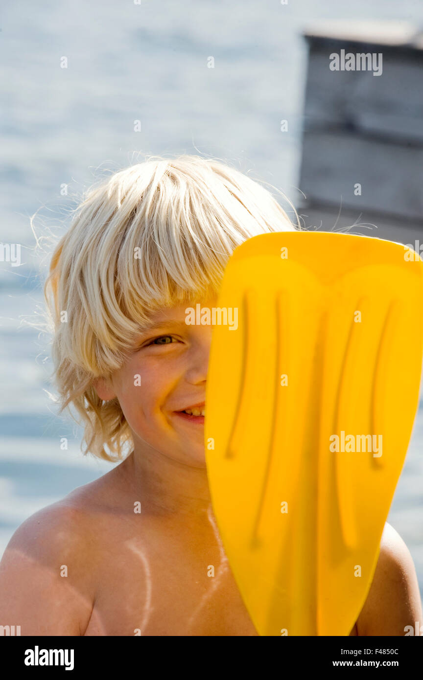 A boy holding a paddle, Sweden Stock Photo - Alamy