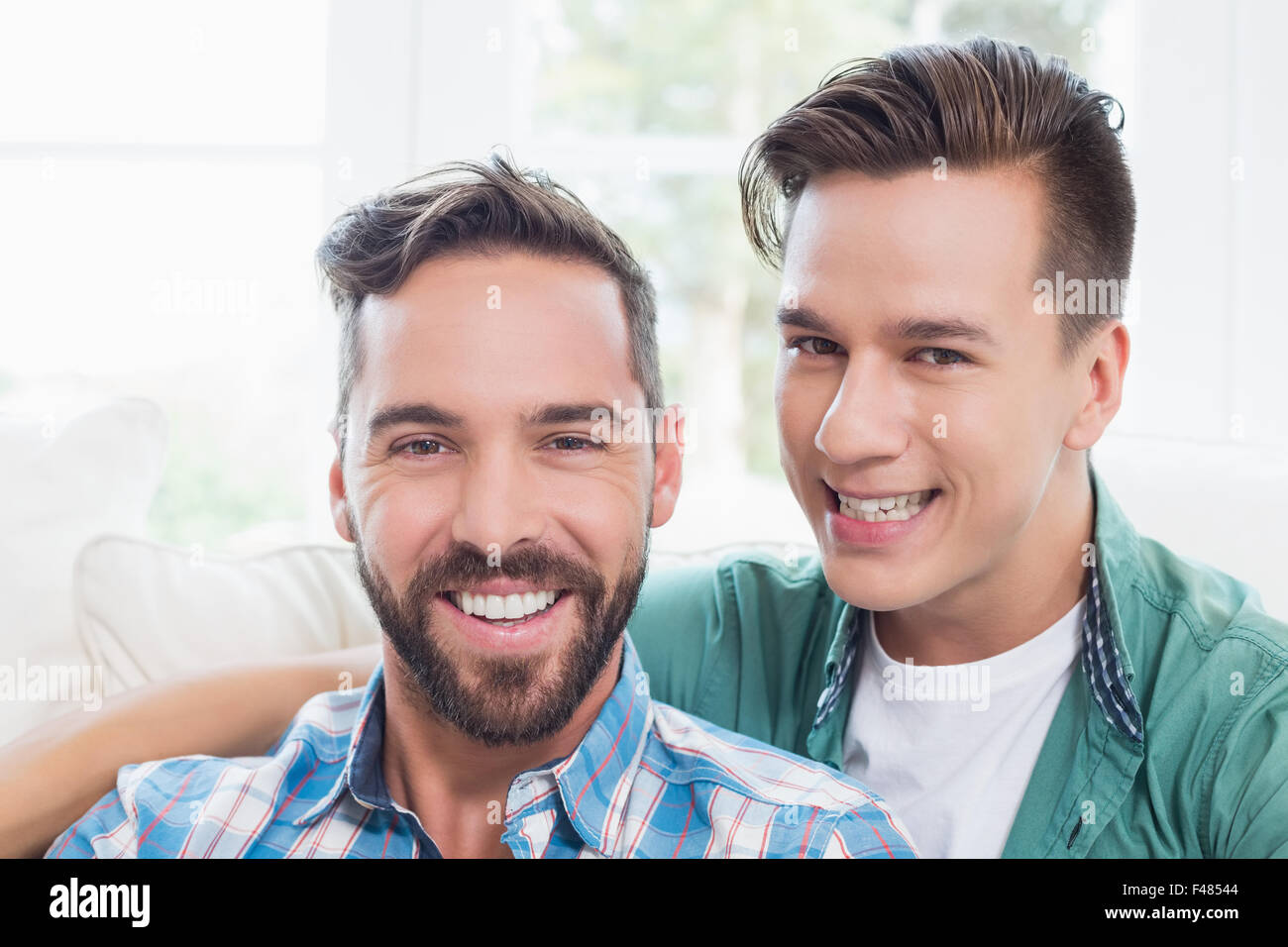 Homosexual couple men looking at the camera Stock Photo - Alamy