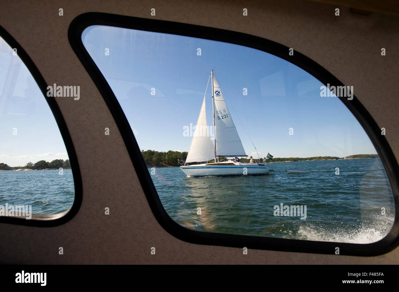 Sailing-boat seen through the window of a motorboat, Sweden Stock Photo ...