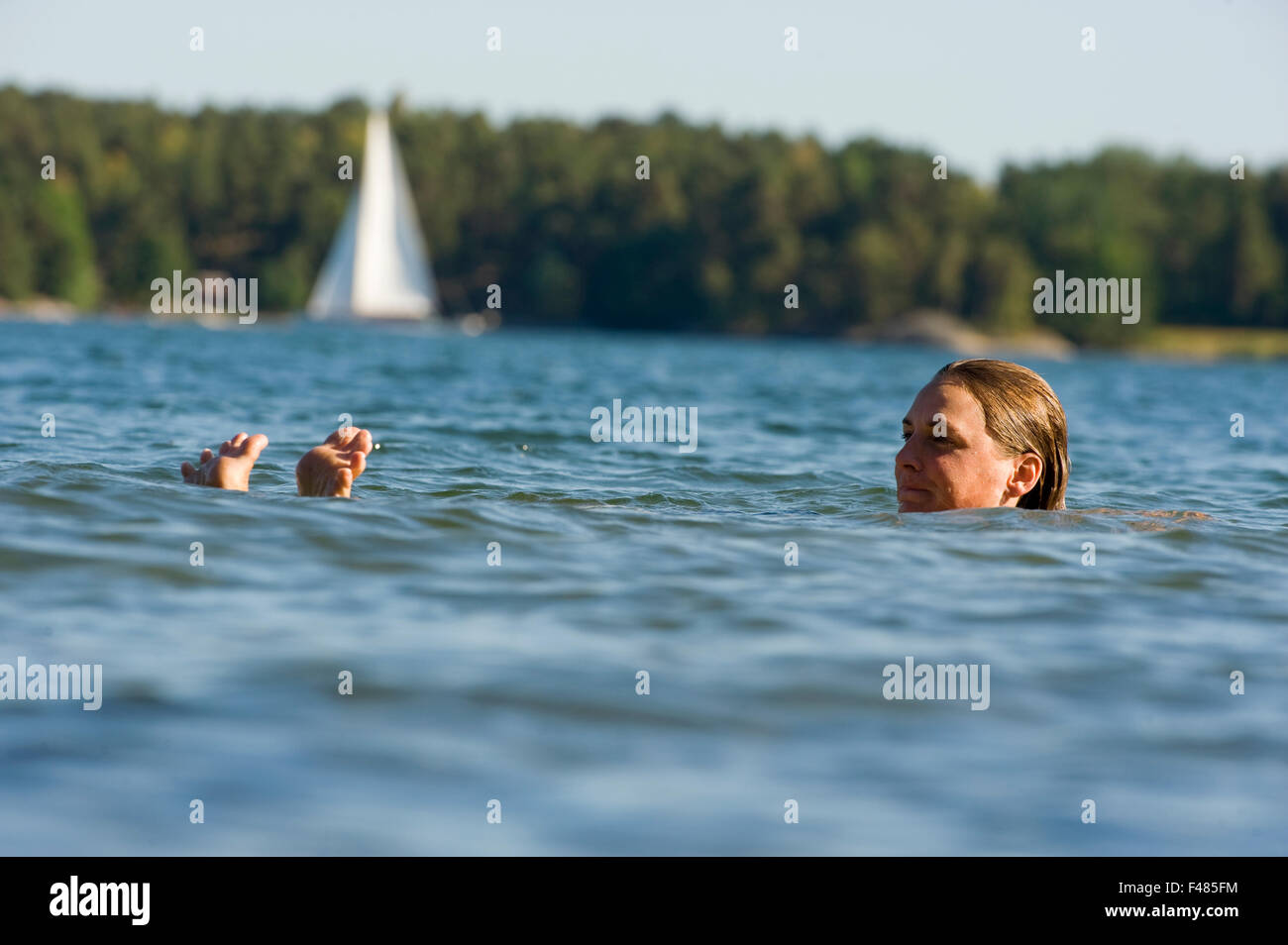 Woman swimming in the sea, Sweden Stock Photo - Alamy