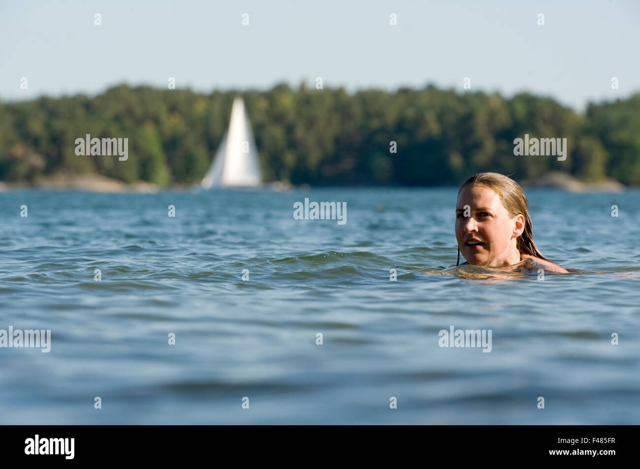 Woman swimming in the sea, Sweden Stock Photo - Alamy