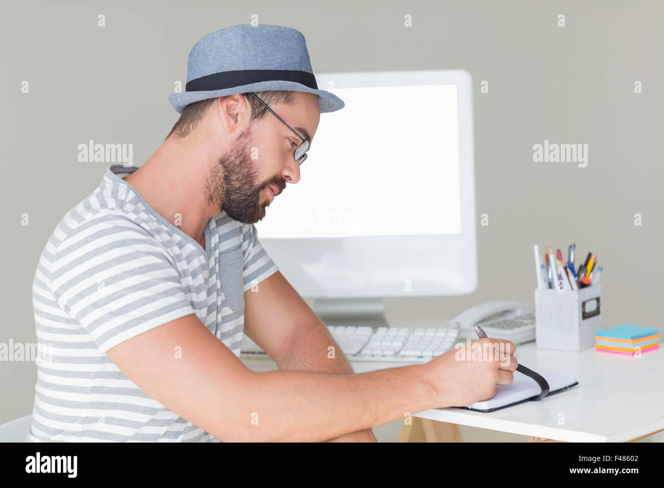 Handsome man writing on notebook Stock Photo - Alamy