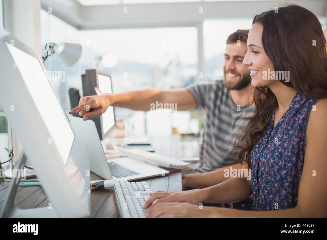 Smiling casual business team working together Stock Photo - Alamy Smiling casual business team working together Stock Photo - Alamy