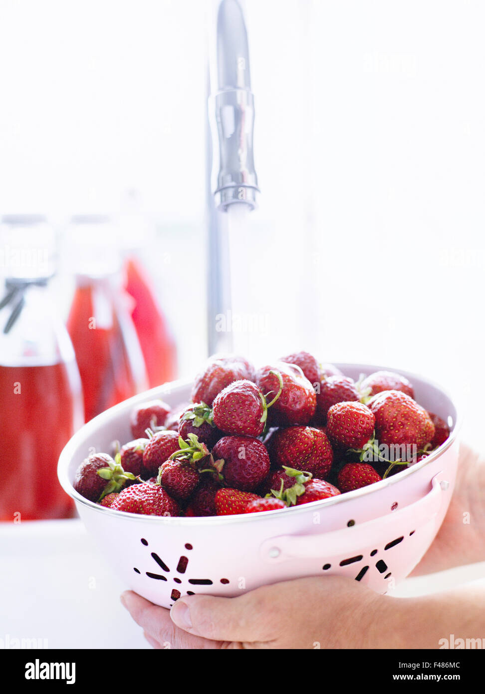 Strawberry in a colander hi-res stock photography and images - Alamy