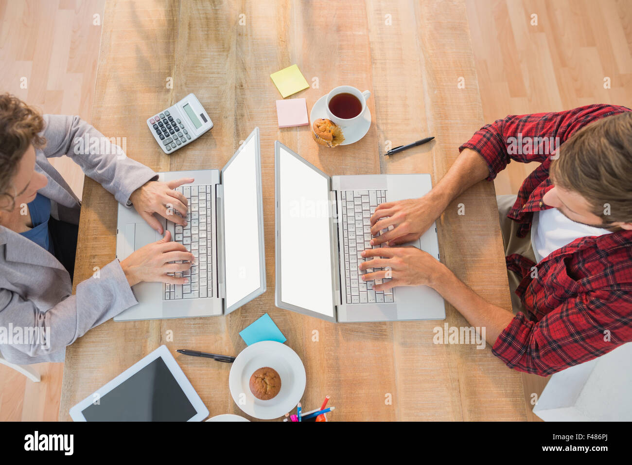 Creative business people typing on laptop Stock Photo - Alamy