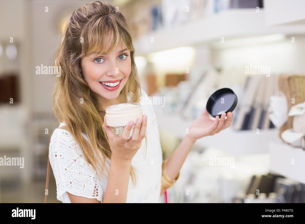 Beautiful customer smelling product Stock Photo - Alamy