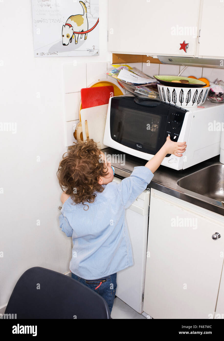 Boy by a microwave, Sweden Stock Photo - Alamy
