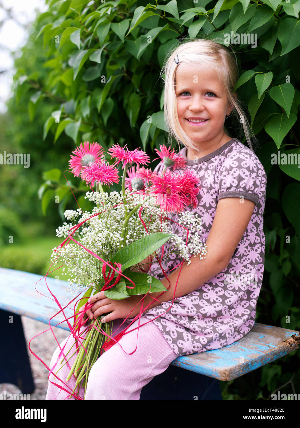 Scandinavian girl with pink flowers, Sweden Stock Photo - Alamy