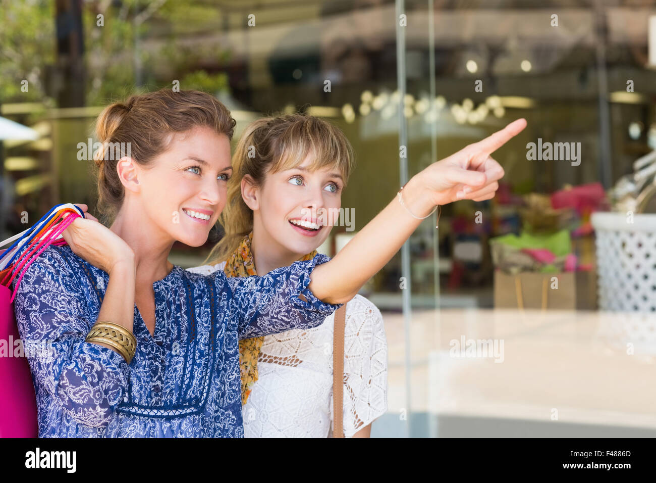 Beautiful women pointing in the distance Stock Photo - Alamy