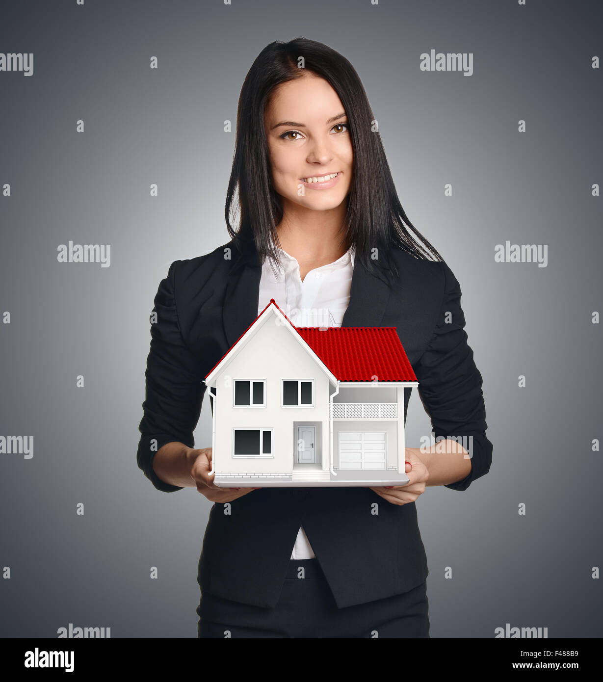 Business woman showing the house. Selling real estate Stock Photo - Alamy