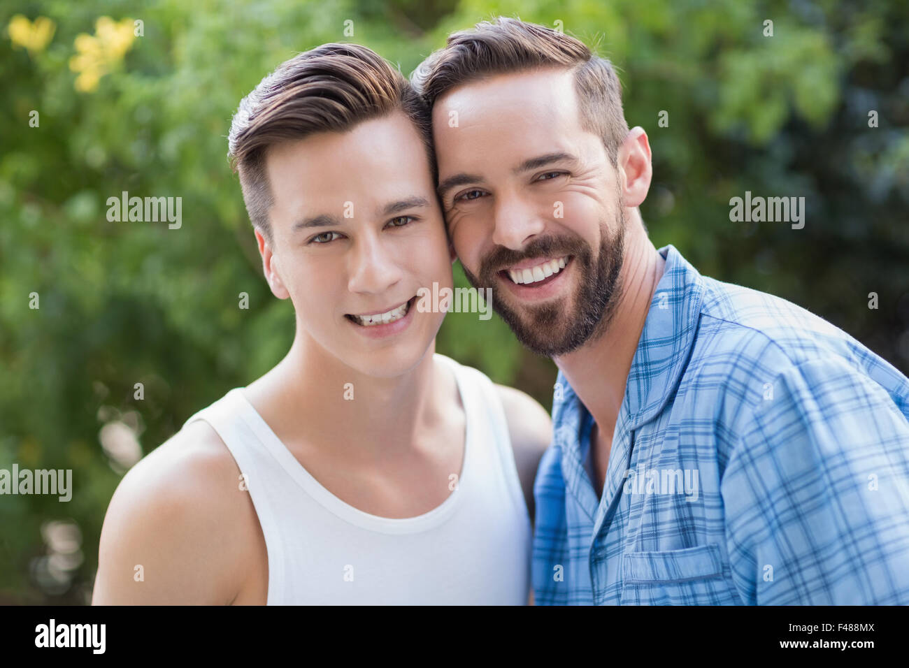 Happy homosexual couple looking at camera Stock Photo - Alamy