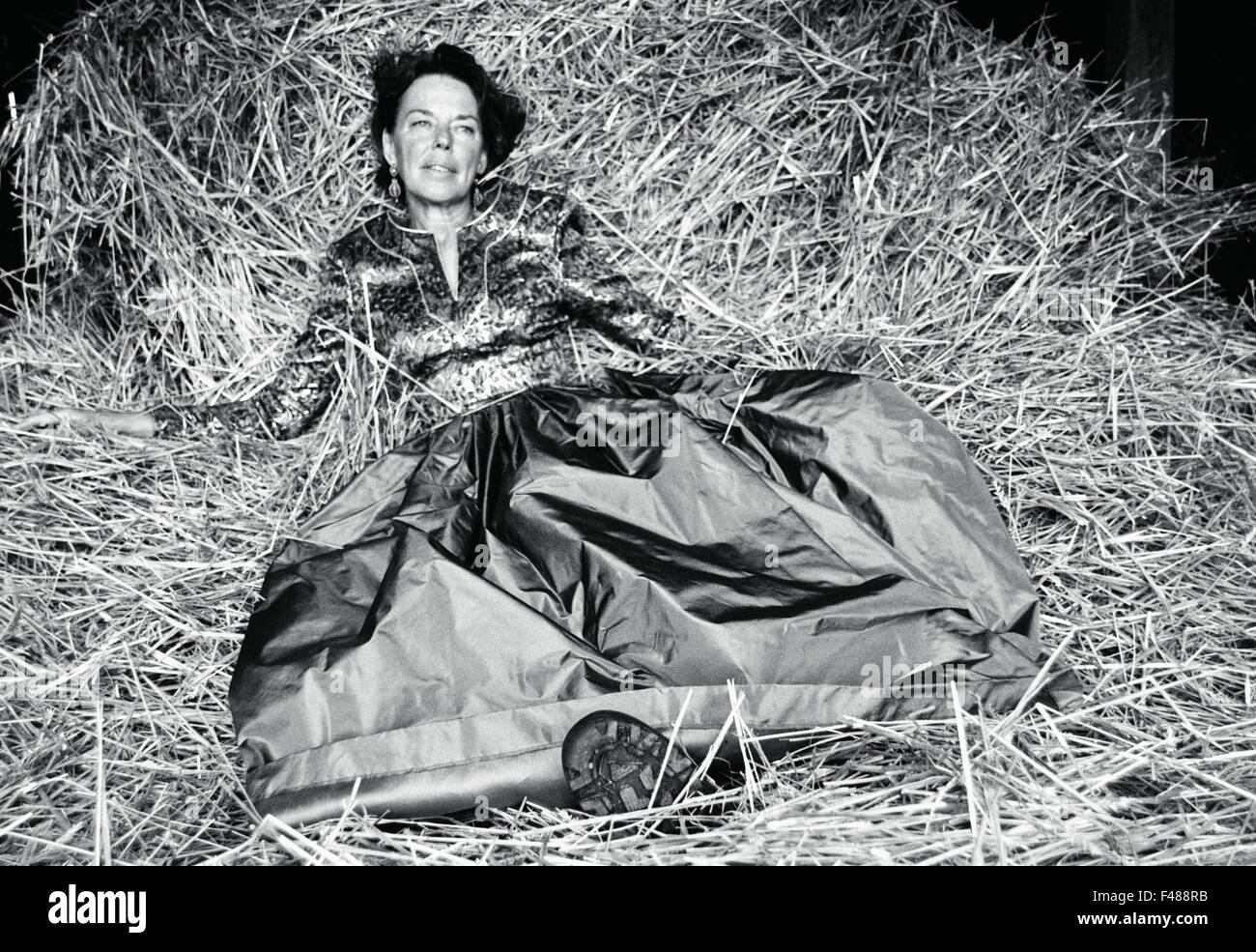 Woman lying on a hayloft in an evening gown, Sweden Stock Photo - Alamy