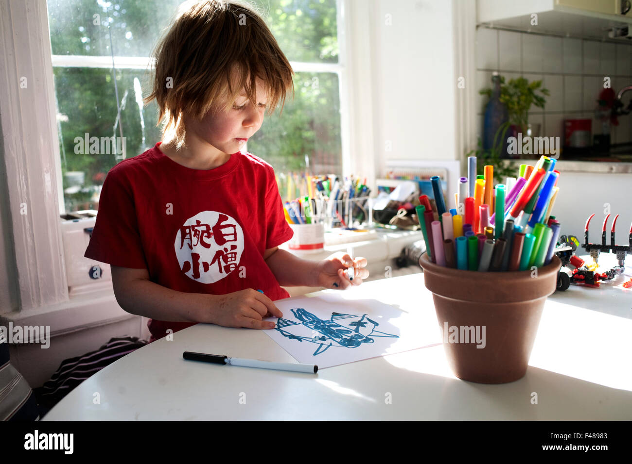 A boy at home drawing, Sweden Stock Photo - Alamy
