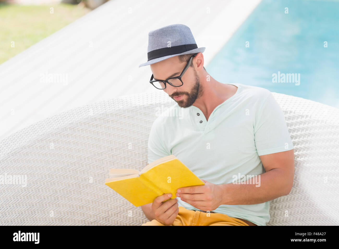 Serious handsome man reading book Stock Photo - Alamy