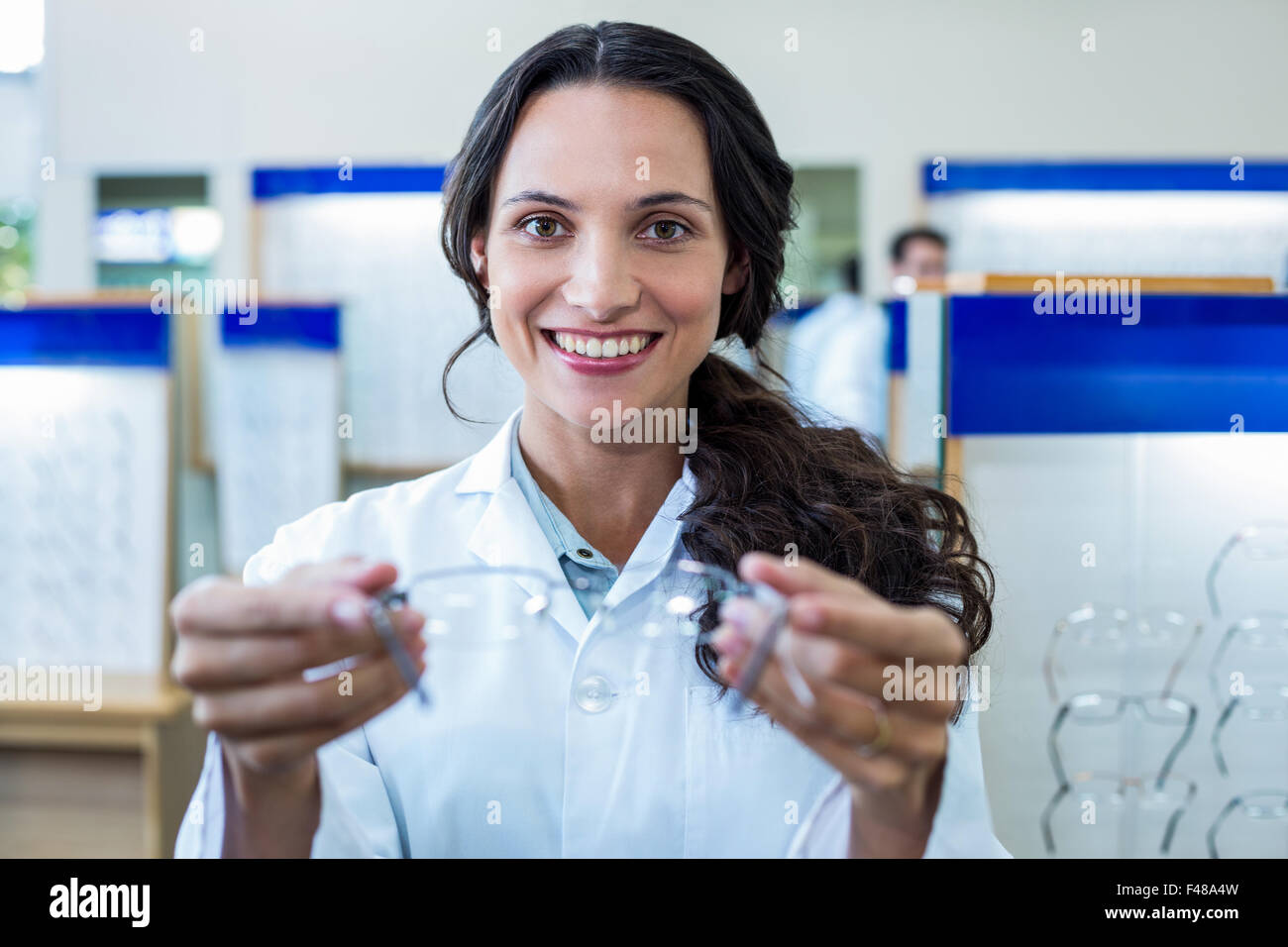 A female optician showing glasses Stock Photo - Alamy