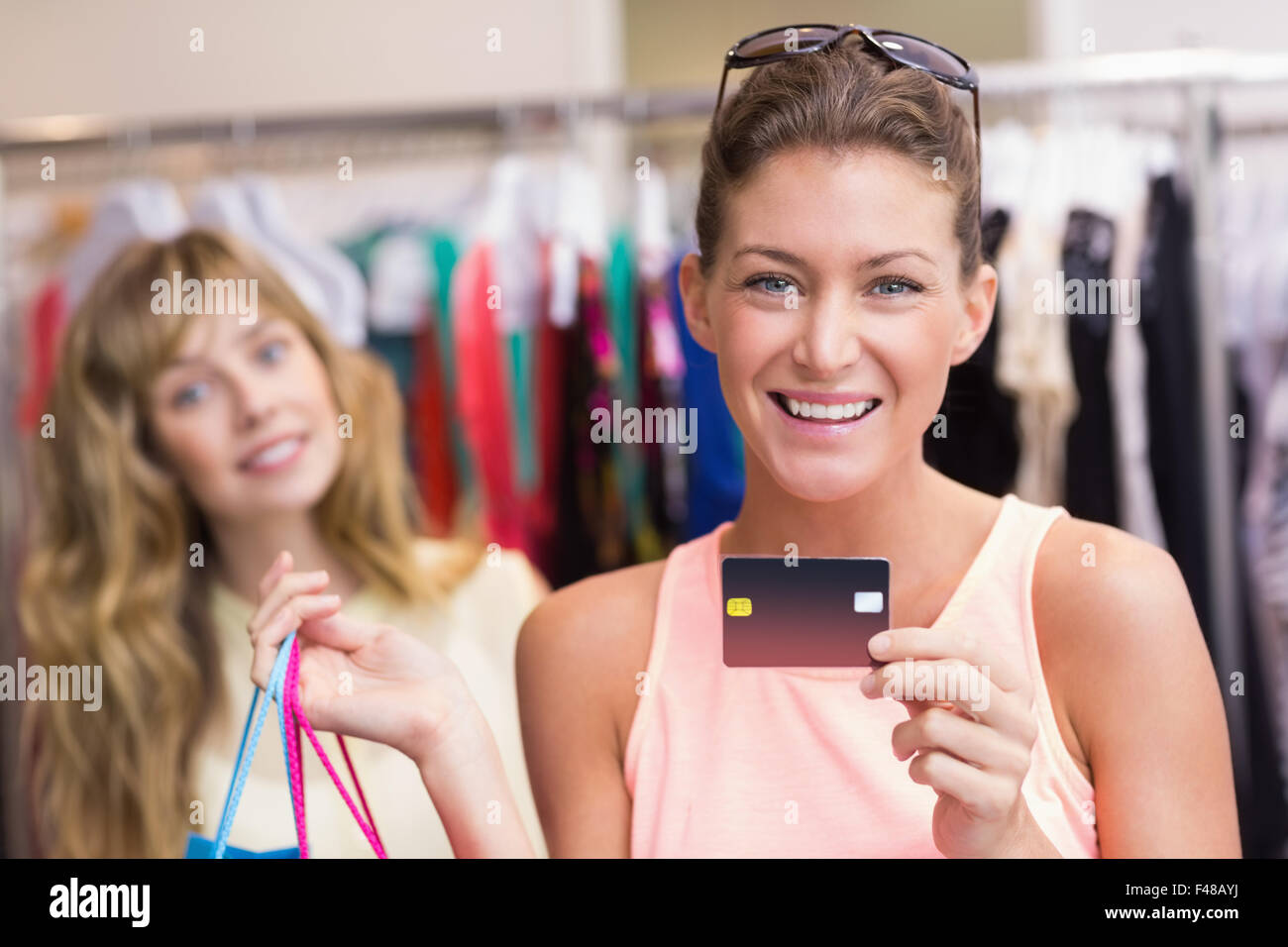 Customer holding shopping bags and credit card Stock Photo - Alamy