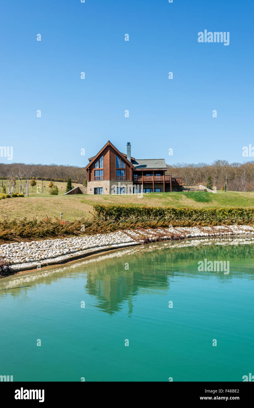 Modern house near water on bright day Stock Photo - Alamy