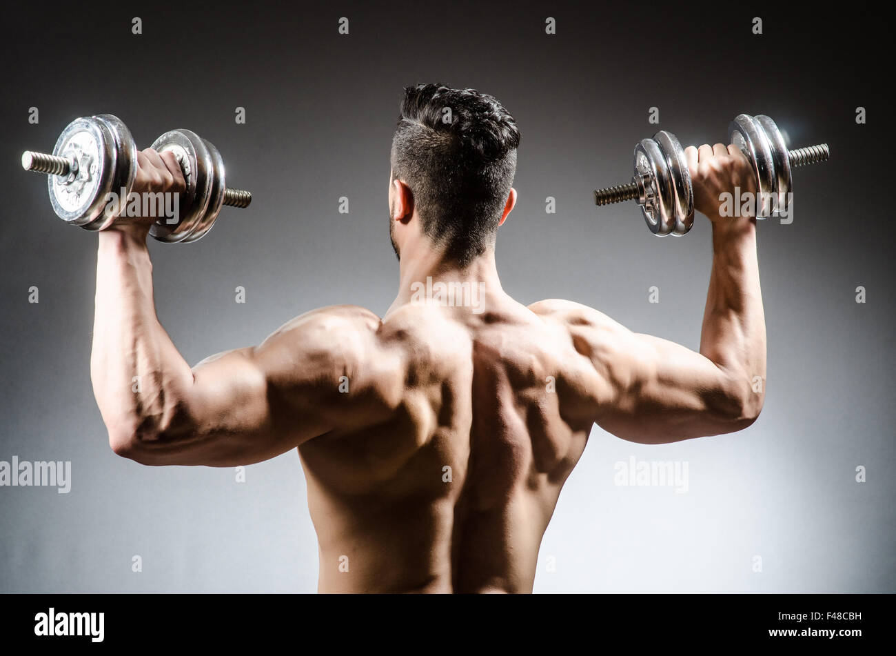 Muscular ripped bodybuilder with dumbbells Stock Photo - Alamy