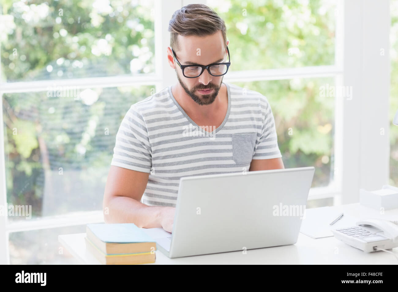 Happy handsome man using his laptop computer Stock Photo - Alamy