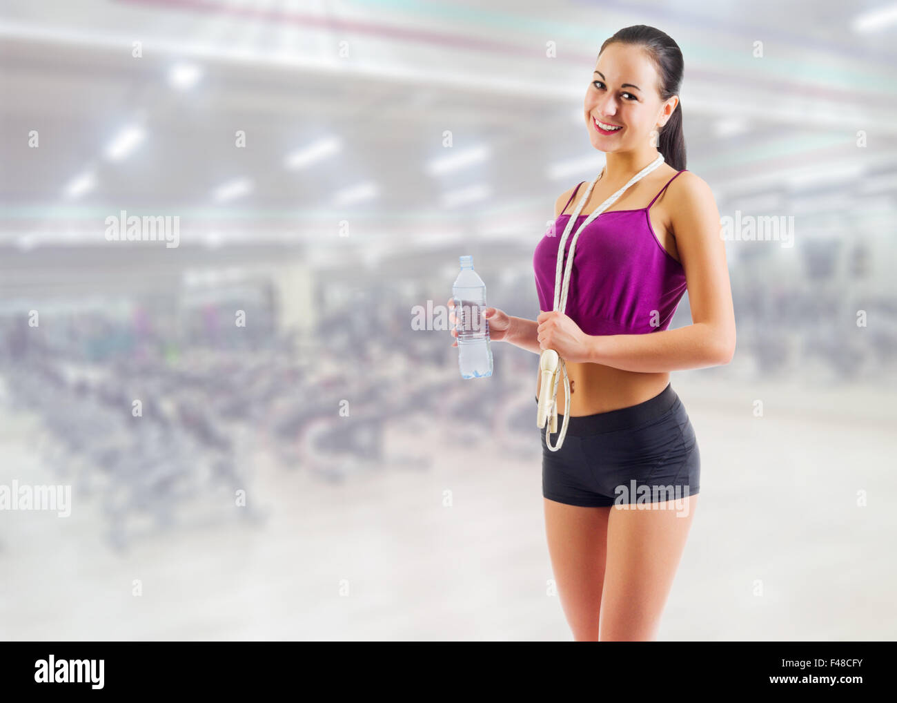 Sporty young girl at fitness club Stock Photo - Alamy