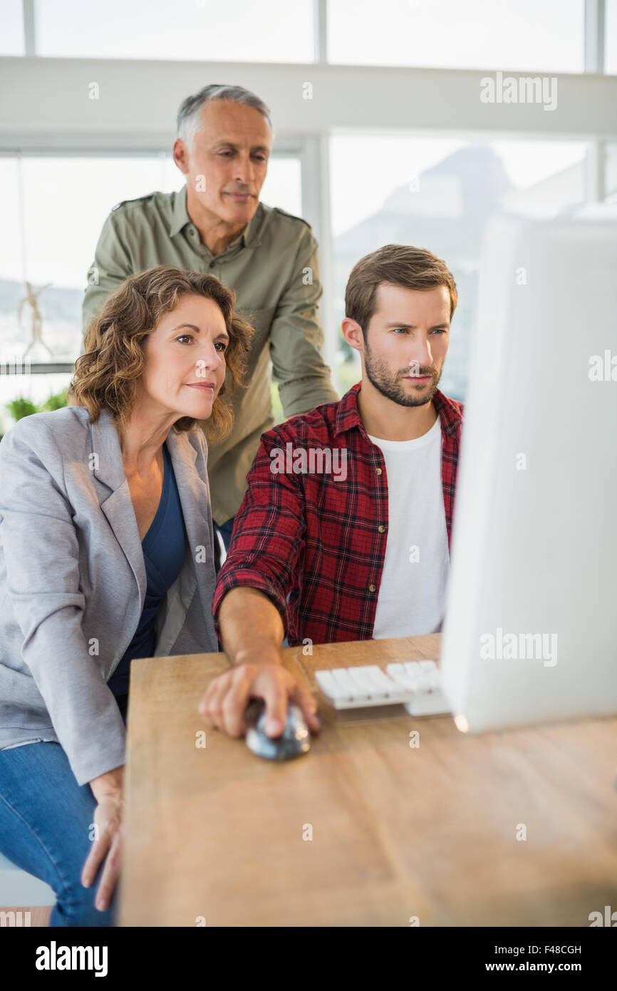 Creative business people using computer on wooden table Stock Photo - Alamy