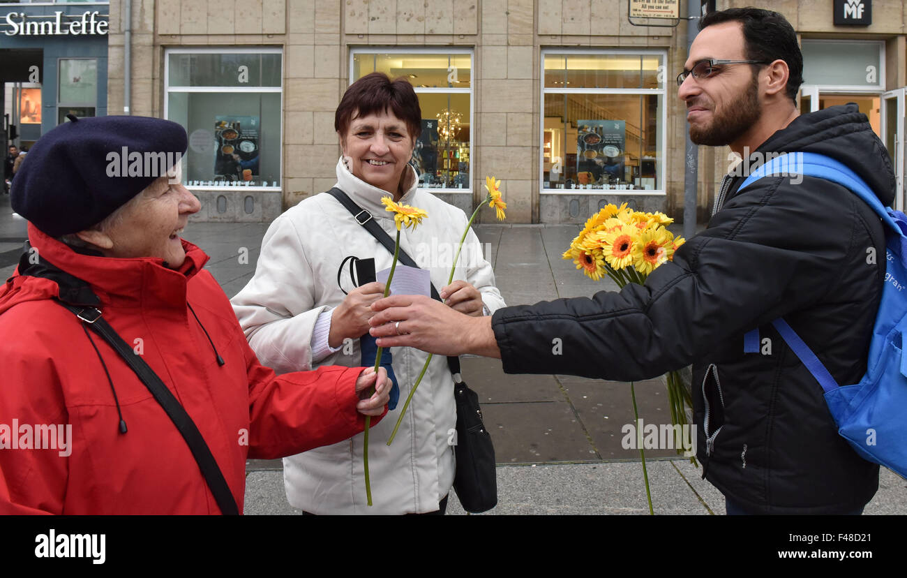 Dresden, Germany. 15th Oct, 2015. Syrian national Mahmoud Shren hands ...