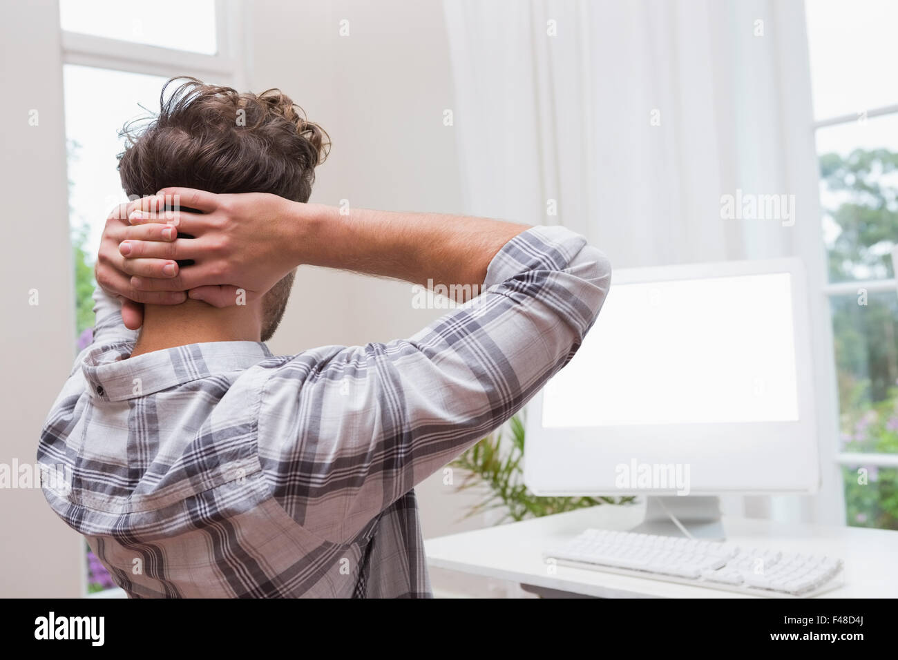 Handsome man relaxing in front of computer Stock Photo - Alamy