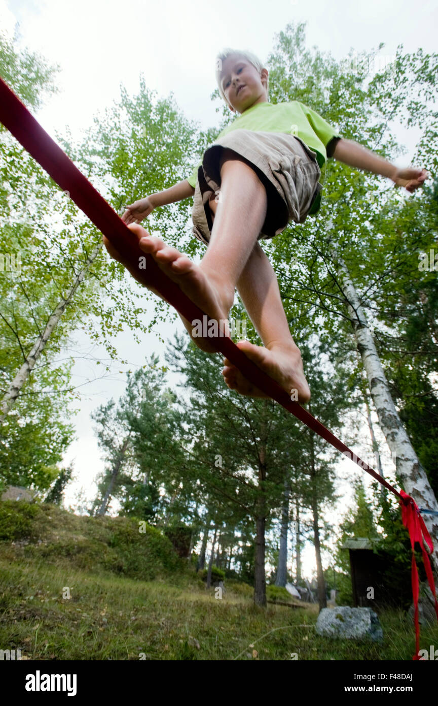 A child walking on a tightrope, Sweden Stock Photo - Alamy