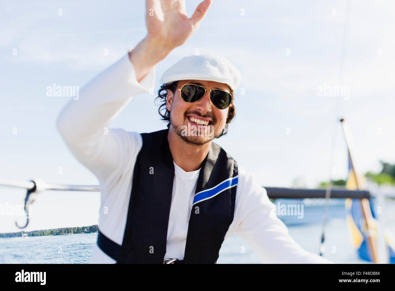 Happy man relaxing sailing boat hi-res stock photography and images - Alamy
