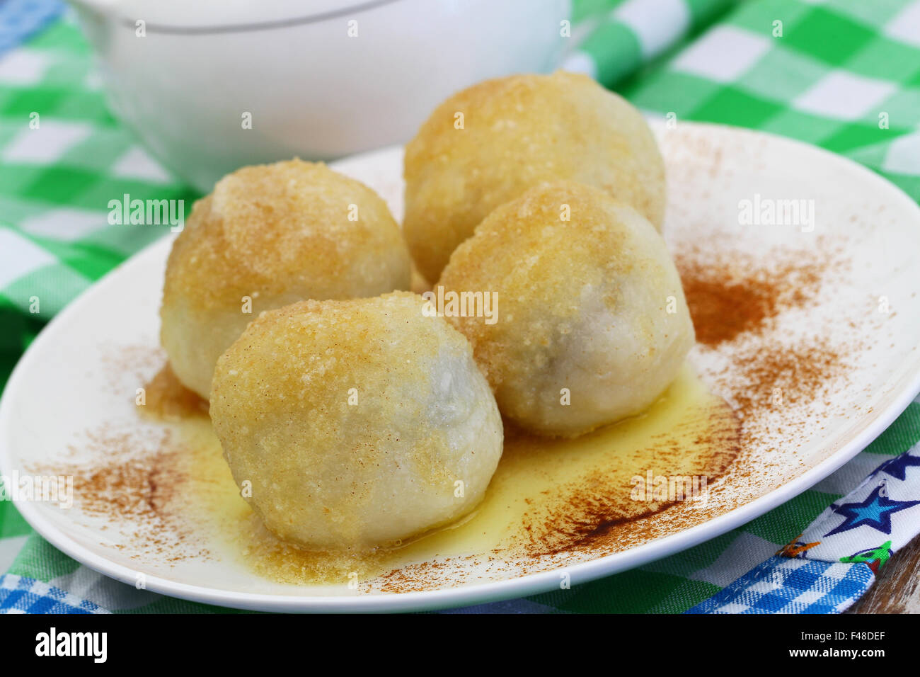 Sweet dumplings sprinkled with sugar and cinnamon, closeup Stock Photo ...