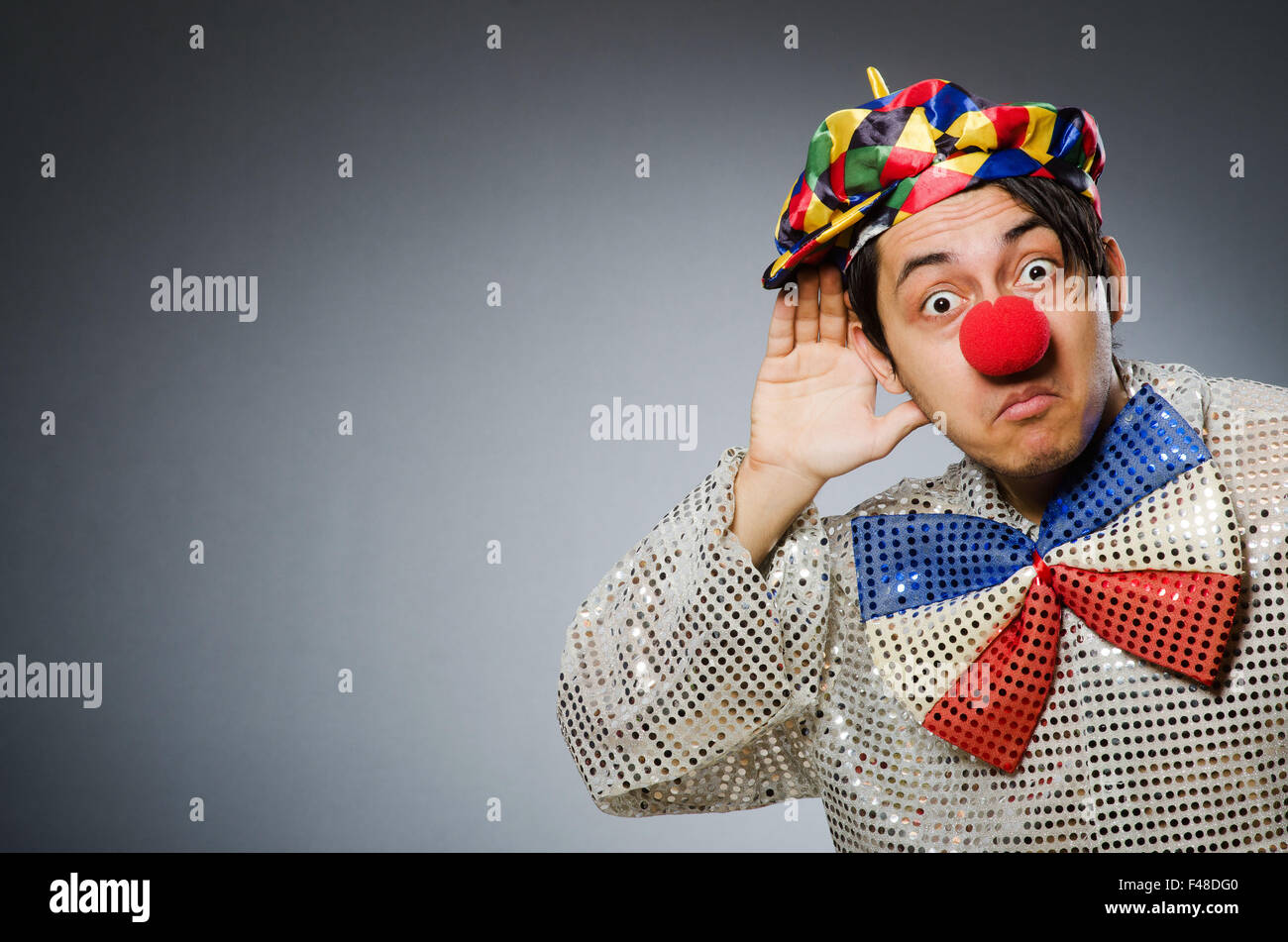 Funny clown against dark background Stock Photo - Alamy