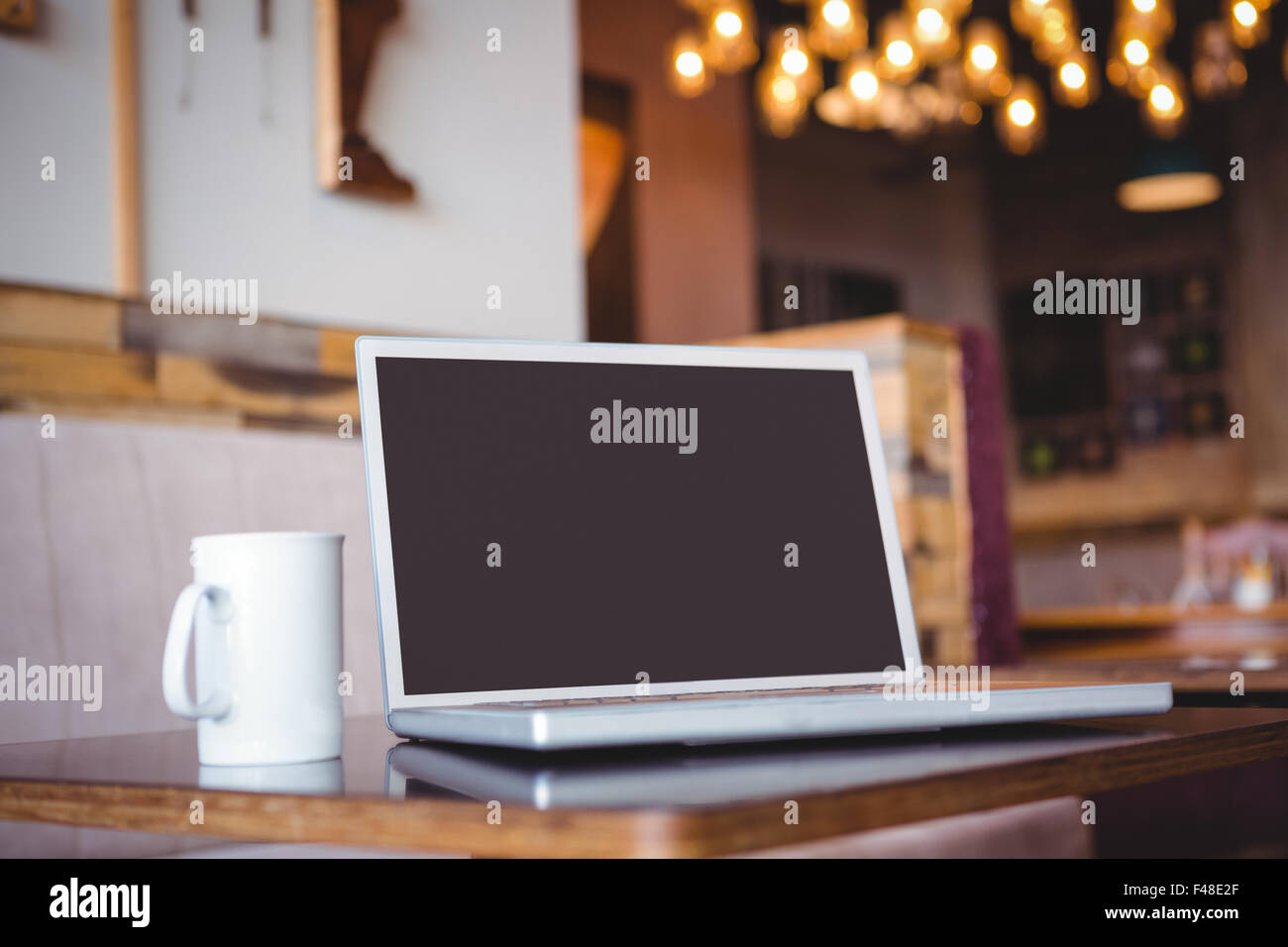 Laptop on a wooden table Stock Photo - Alamy