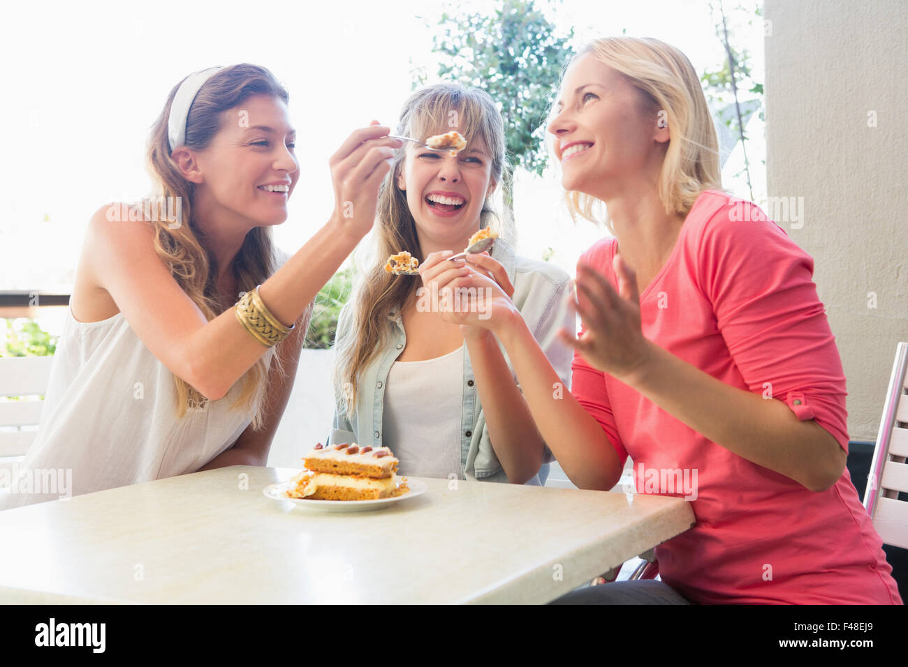 Happy friends having a cake Stock Photo - Alamy