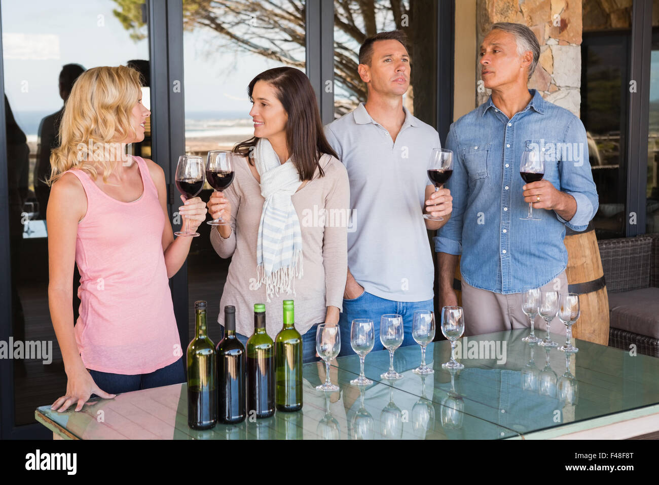 Happy friends in a wine tasting having wine Stock Photo - Alamy