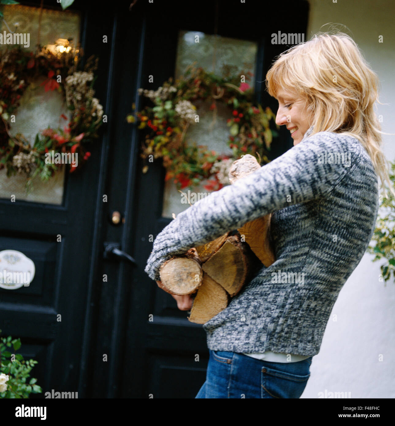 Woman carrying firewood hi-res stock photography and images - Alamy