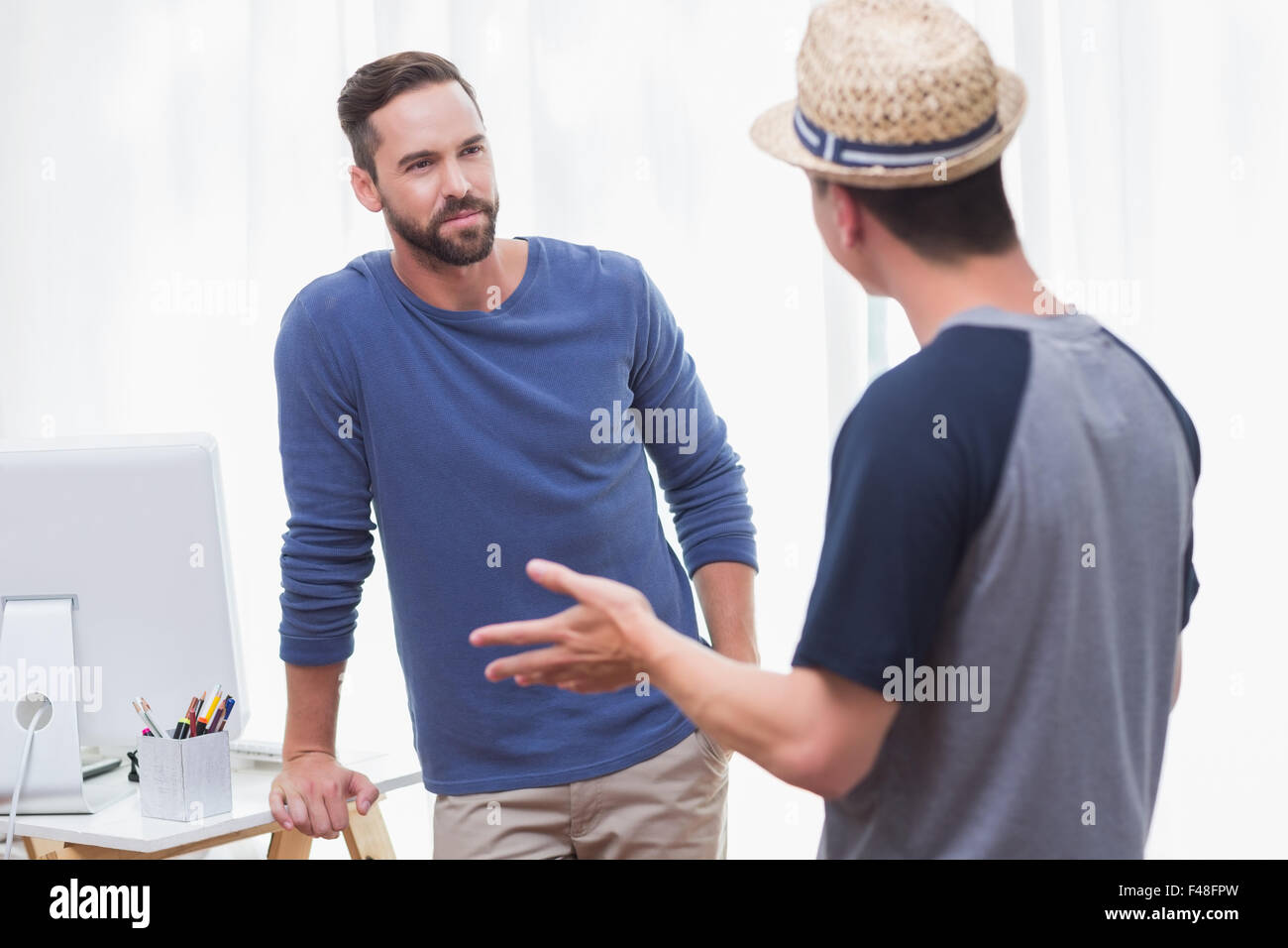 Casual business people speaking together Stock Photo - Alamy