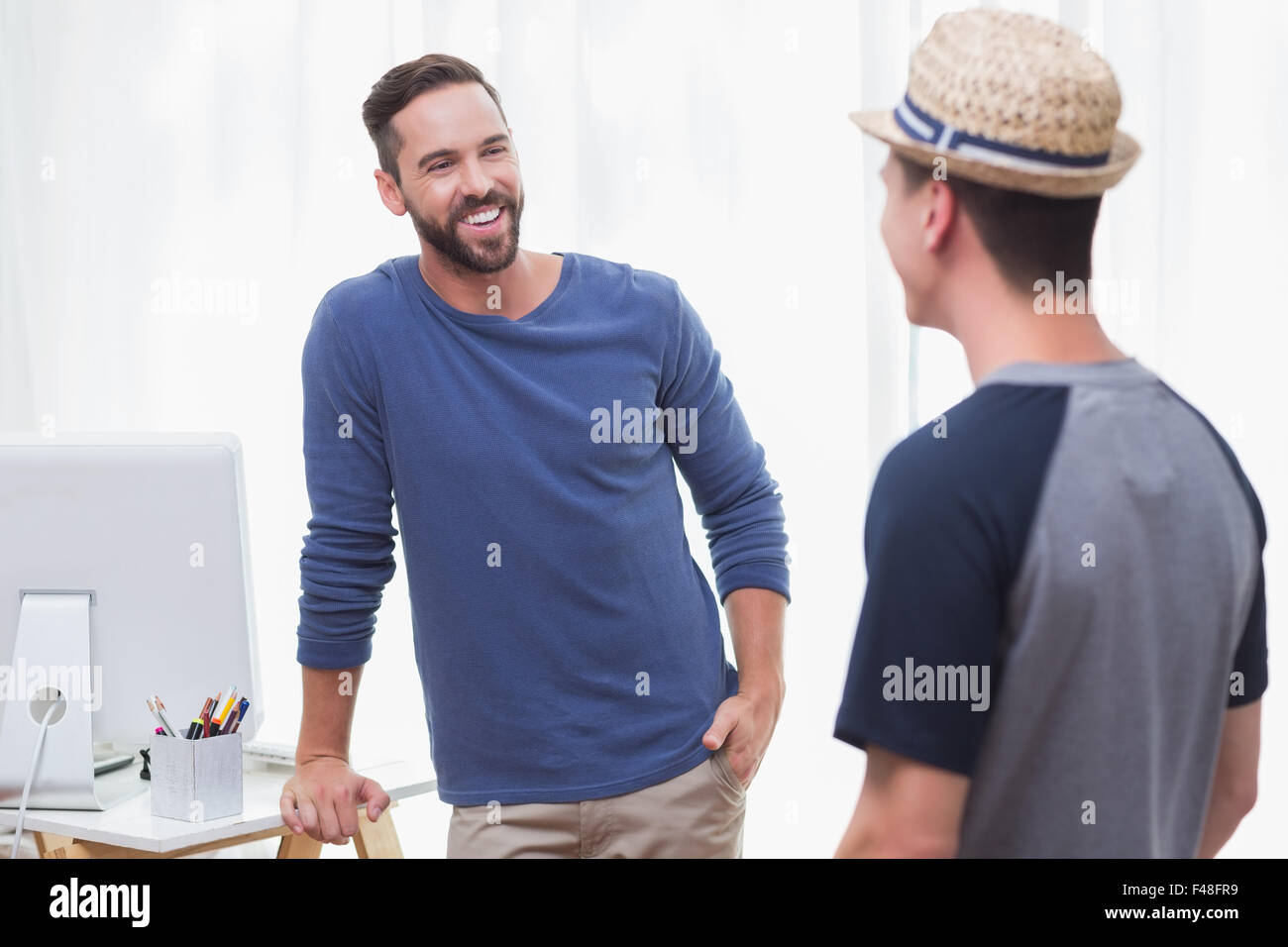 Casual business people speaking together Stock Photo - Alamy