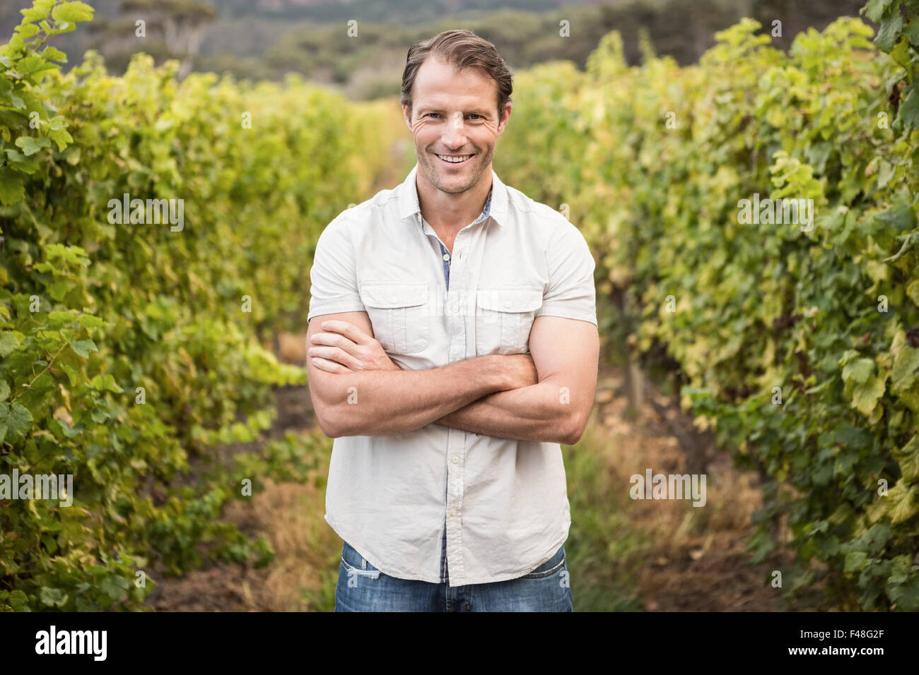 Happy vintner with crossed arms Stock Photo - Alamy