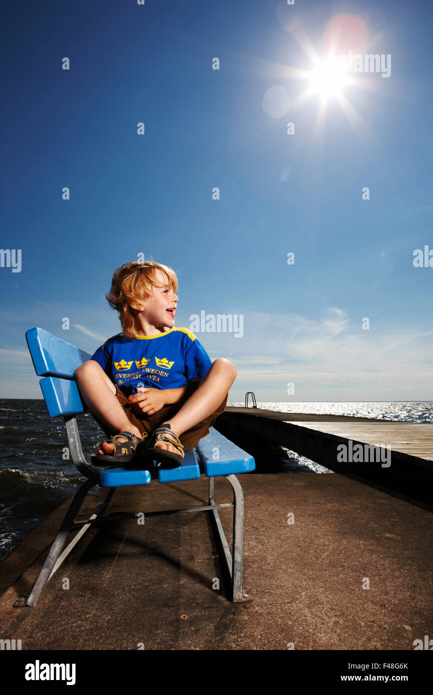 Boy on a jetty, Sweden Stock Photo - Alamy