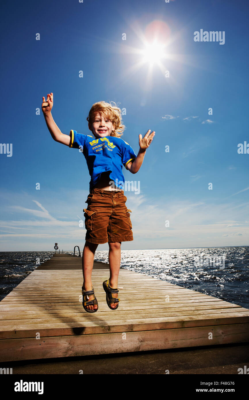 Boy on a jetty, Sweden Stock Photo - Alamy