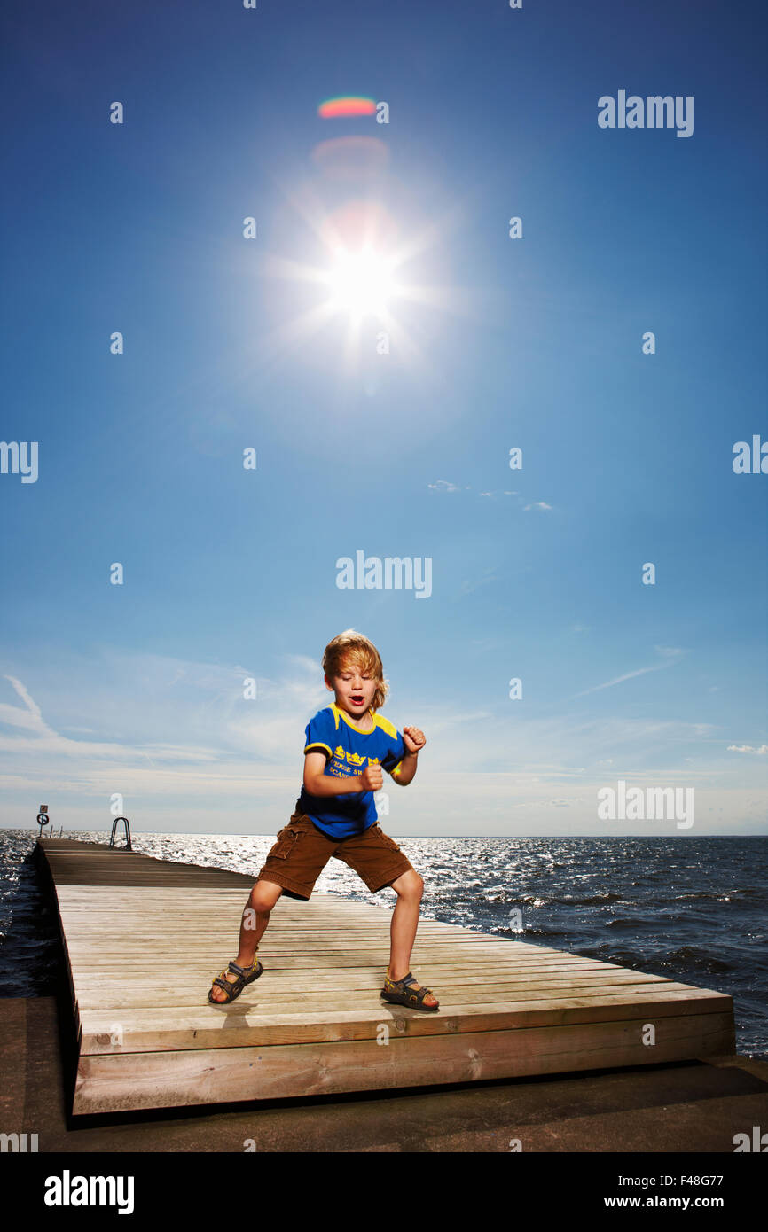 Boy on a jetty, Sweden Stock Photo - Alamy
