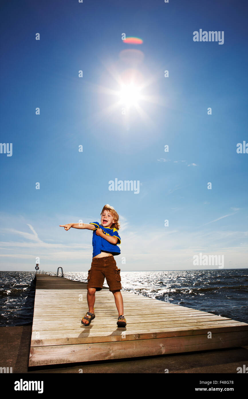 Boy on a jetty, Sweden Stock Photo - Alamy