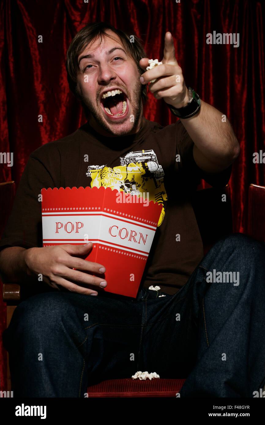 Man watching a movie Stock Photo - Alamy