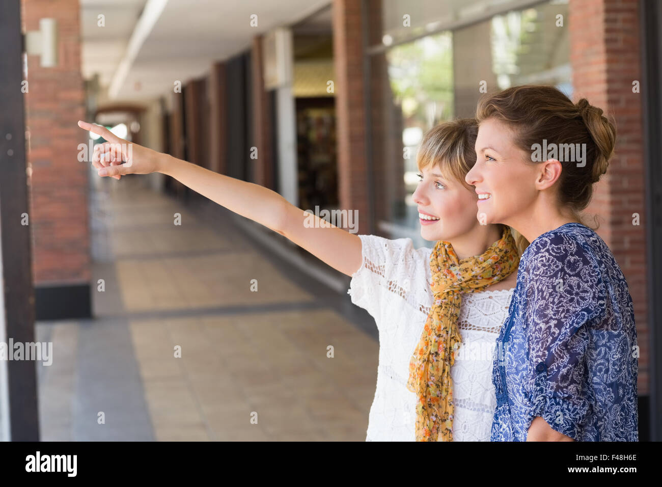 Beautiful women pointing in the distance Stock Photo - Alamy