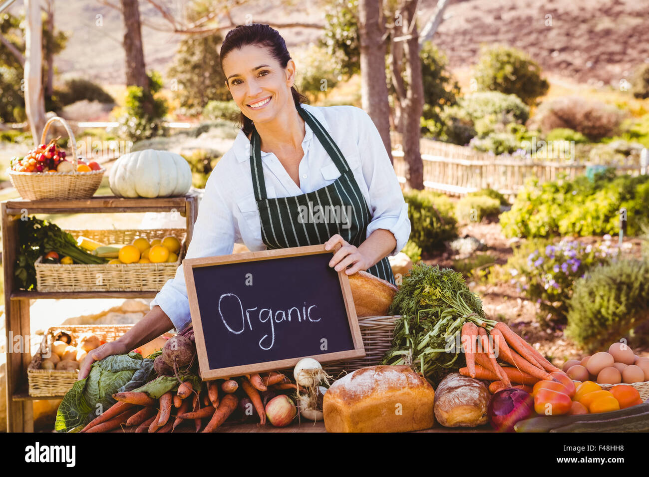 Woman selling organic vegetables at market Stock Photo - Alamy